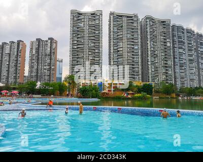 People swim at Sichuan's biggest outdoor swimming pool that is paved ...