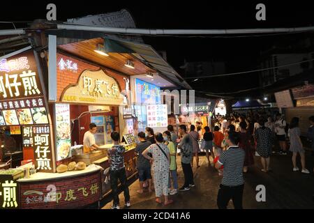 Tourists crowd at Zengcuoan, a local tourist spot famous for its night ...