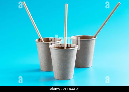 Green paper cups with paper straw on yellow background. Eco-friendly ...