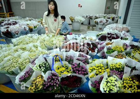 Vendors sell flowers at the Kunming Dounan Flower market, home to over ...