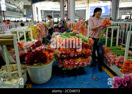 Vendors sell flowers at the Kunming Dounan Flower market, home to over ...