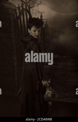 Halloween creepy boy with doll Stock Photo - Alamy