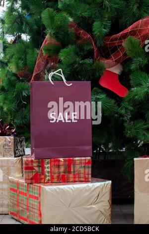 Beautiful gift lies near the Christmas tree Stock Photo - Alamy