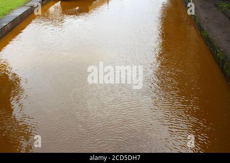 Rich brown colour of Bridgewater Canal (brown river) in Worsley village ...