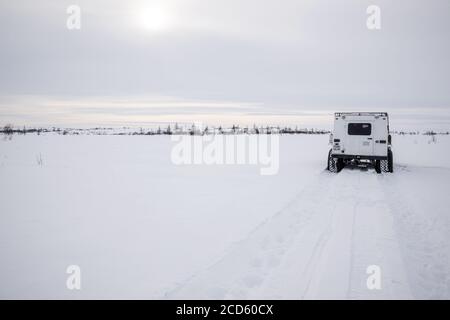 A trekol (russian all terrain six wheels vehicle) in the snow, tundra ...