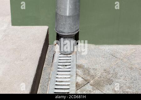 an engineering structure a downspout with a drainage grate for drainage ...