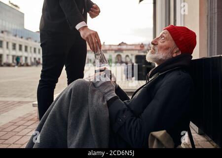 Rich and poor on a street in Knightsbridge, London UK Stock Photo - Alamy