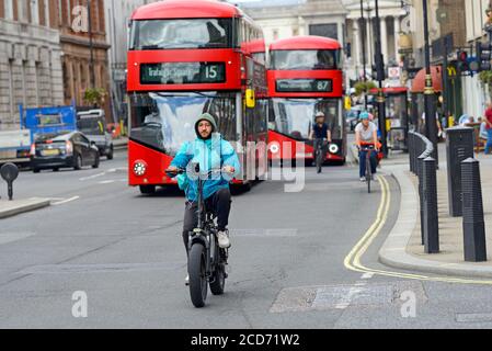 buses and cyclists in London Stock Photo - Alamy