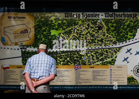 A visitor looks to a tour map before entering the historical Wolf's ...