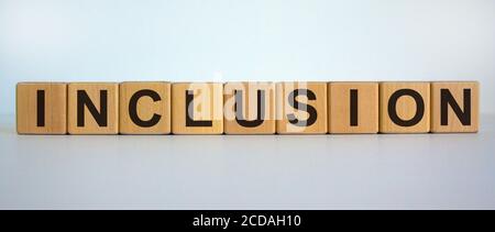 Symbol for a better inclusion. Wooden cubes with word 'inclusion ...