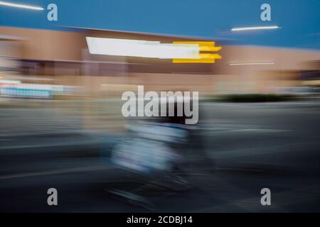 Frantic shopper pushing shopping cart outside store Stock Photo - Alamy