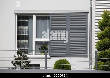 home windows with modern sliding shutters in house facade Stock Photo ...
