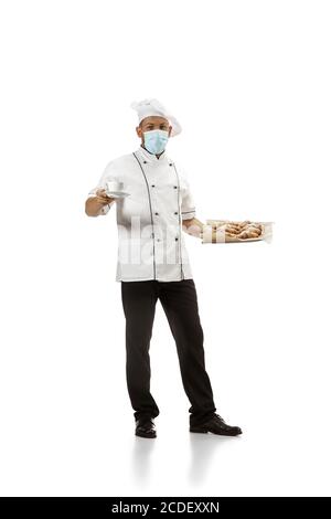 Cooker, chef, baker in face mask in uniform on white background with ...