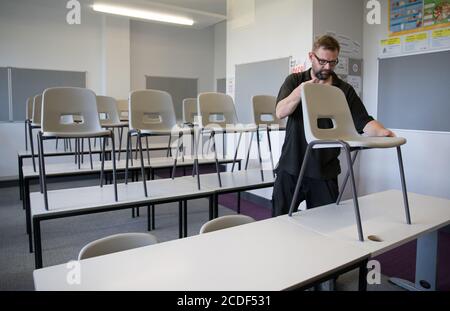 Chairs are taken down in a classroom at Ark Charter Academy in ...