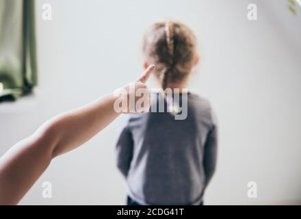 Child bully pointing finger at blurred unrecognizable victim child who ...