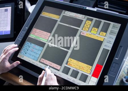 Digital flight progress strips, seen on an air traffic controller's ...