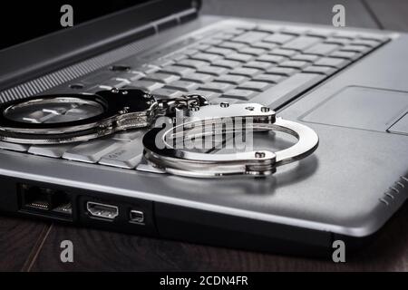 Handcuffs on the laptop, cyber crime. Cyber security concept Stock ...