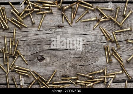 screws on a wooden table Stock Photo - Alamy