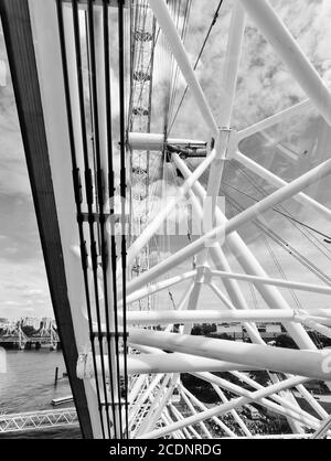 Ferris wheel construction seen from one of the cabins. Part of a white ...