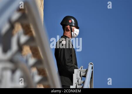 A Turkish soldier wearing a protective face mask stands during a change ...