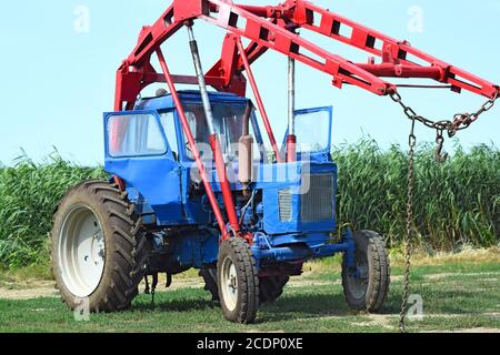 blue tractor to collect hay in bales, tractor bale hay in field ...