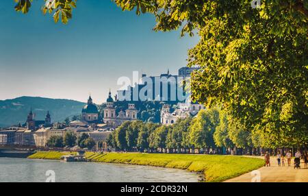 People enjoy the sunset at the baroque castle of Nymphenburg in Munich ...