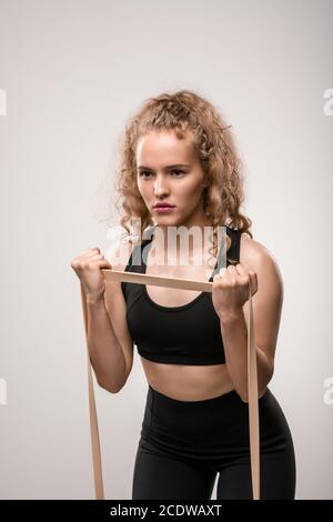 Women exercising with elastic band in the park Stock Photo - Alamy