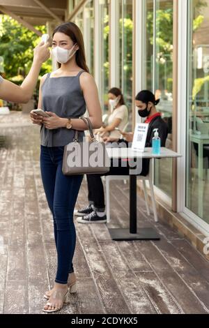 Take temperature for restaurant new normal Stock Photo - Alamy