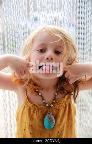 Toddler making a cheeky face Stock Photo - Alamy