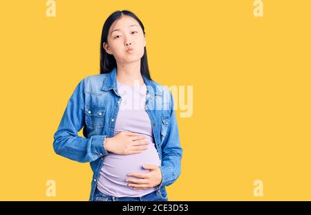 Funny woman baby blowing puffing cheeks Stock Photo - Alamy