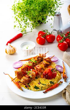 Shish kebabs with vegetables and bulgur Stock Photo - Alamy