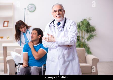 Two doctors visiting sick man at home Stock Photo - Alamy