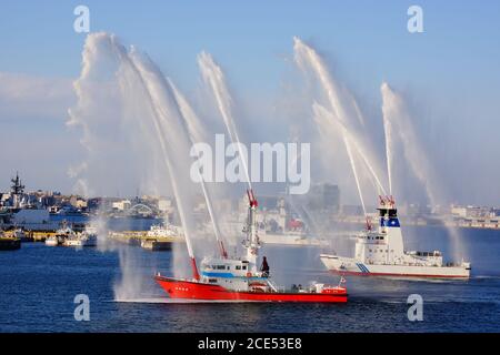 Fire fighting vessels to the water discharge training Stock Photo - Alamy