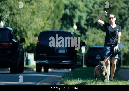 A woman gives thumbs down as U.S. President Donald Trump's motorcade ...