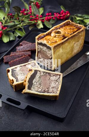 Traditional German meat paste offered as closeup on a black board with ...