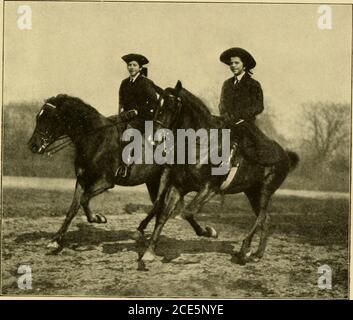 Young woman pulling off her riding boots using a boot-jack Stock Photo ...