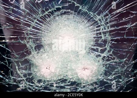 Cracked bulletproof glass is seen witrh bullets inside Stock Photo - Alamy