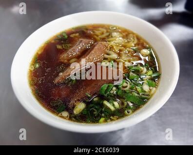 Chinese Braised Beef Noodle Soup with Green Vegetables. Traditional ...
