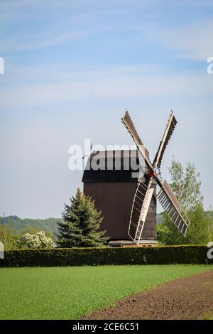View of a well-preserved old post mill Stock Photo - Alamy