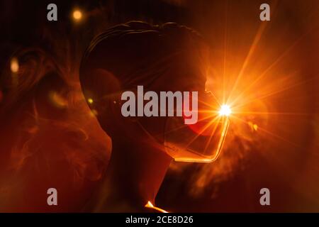 Female mannequin in protective respirator placed in dark studio with ...