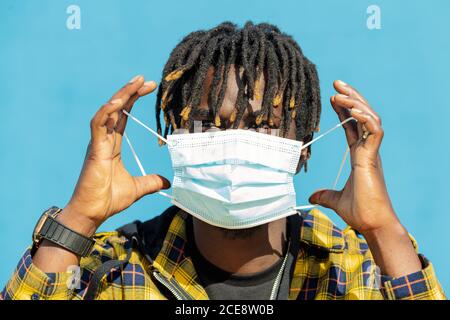 Attractive man wearing protective medical mask taking a selfie isolated ...
