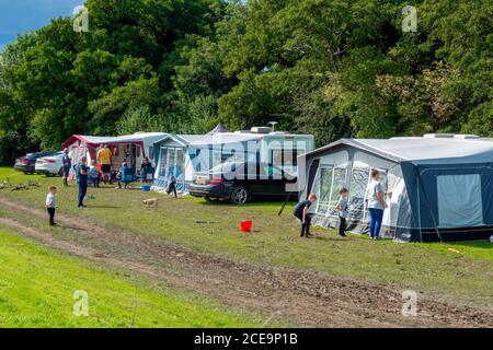 Caravans and camping tents at busy campsite in the dunes along the ...