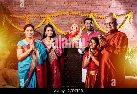Family performing a pooja Stock Photo - Alamy