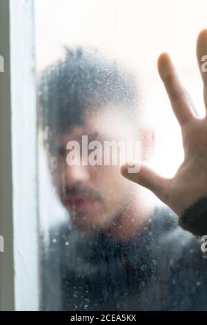 man behind steamy glass with hand on it Stock Photo - Alamy