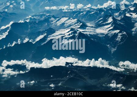 View on mountain and clouds from plane Stock Photo - Alamy