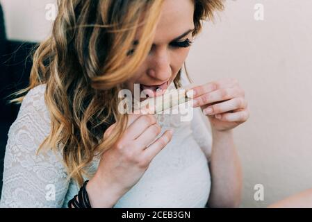 Close-up Portrait Igniting Joint and Smoking a Hand-Rolled Cigarette in ...