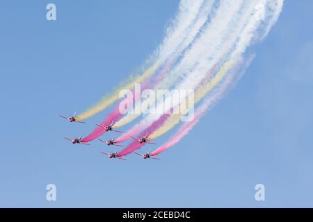 Group of jets emitting colored smoke while flying on background of ...