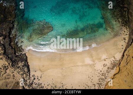 Rocks on sandy beach with tropical vegetation, Tonga Quarry, Tonga Bay ...