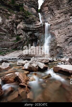 A beautiful landscape of a waterfall streaming from the middle of a ...