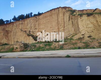 A low angle shot of a rocky mountain under a blue sky in winter Stock ...